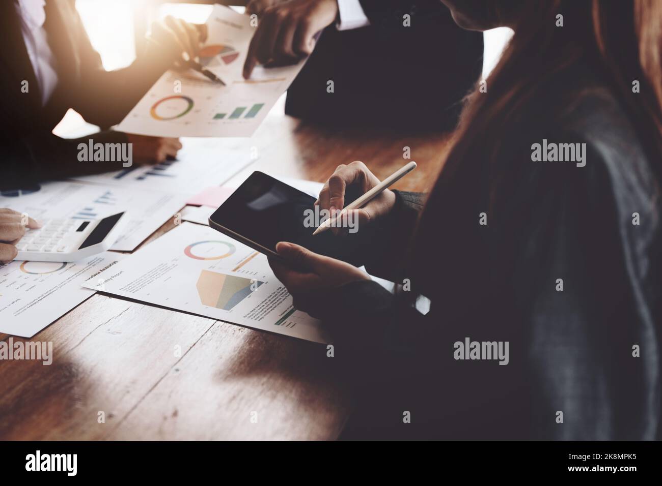 businesspeople working with partners is adjusting marketing strategies ...