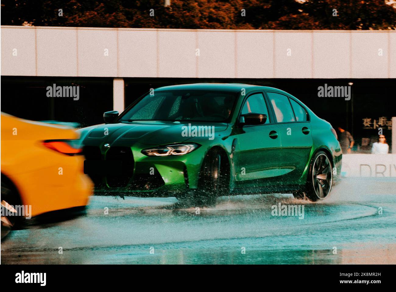 A young man drifting a green car during the race in Shanghai, China ...