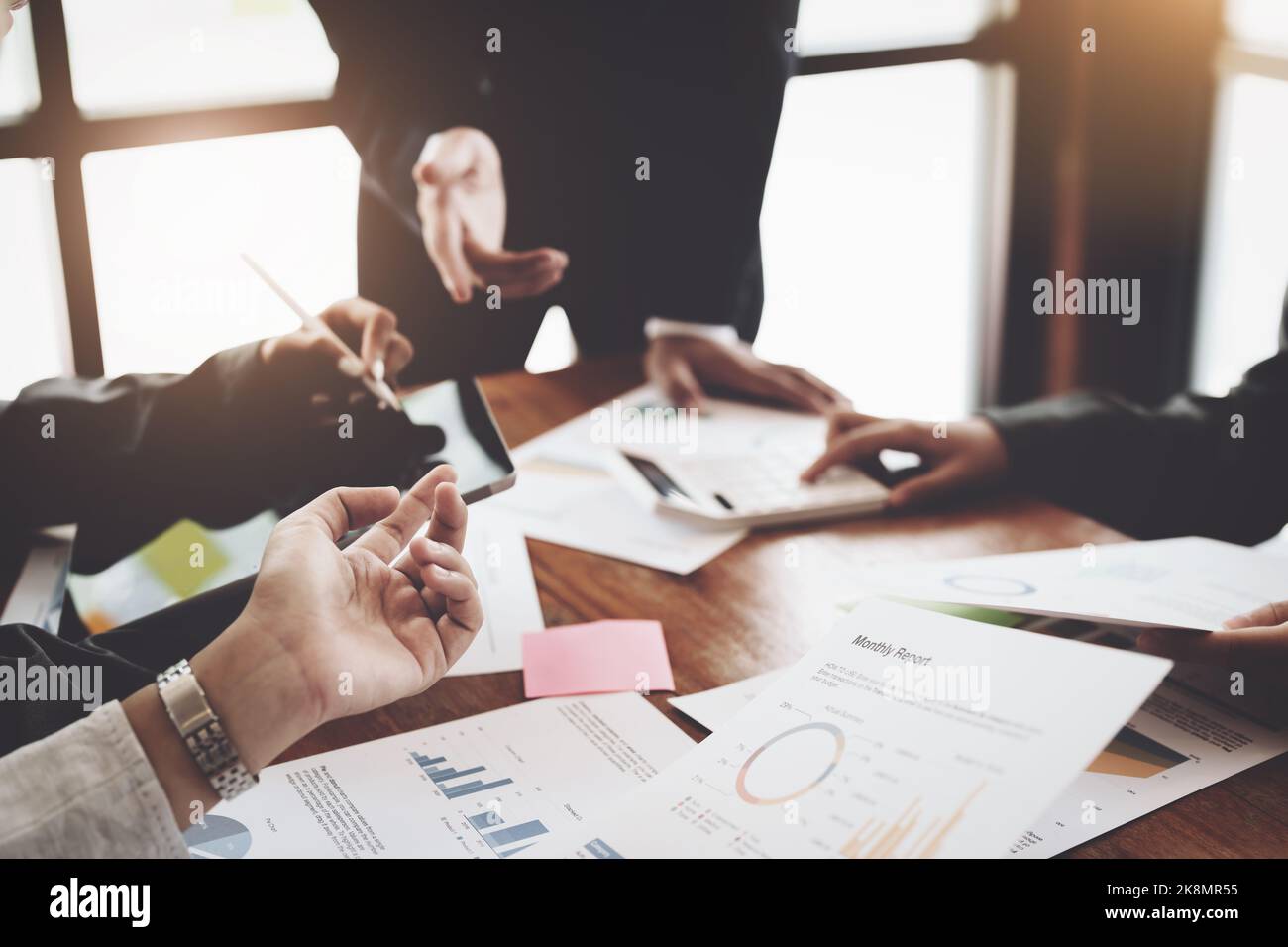 businesspeople working with partners is adjusting marketing strategies ...