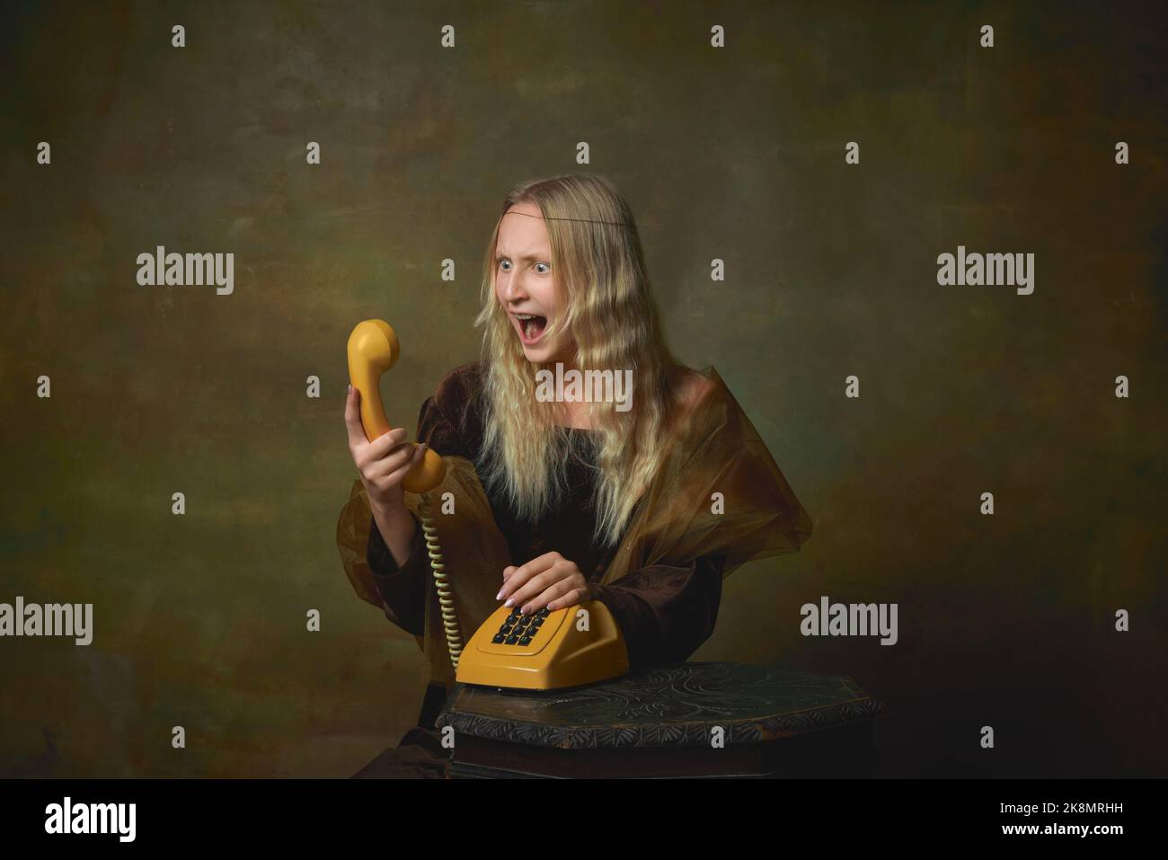 Scream. Shocked young girl as Mona Lisa picture talking on retro phone ...