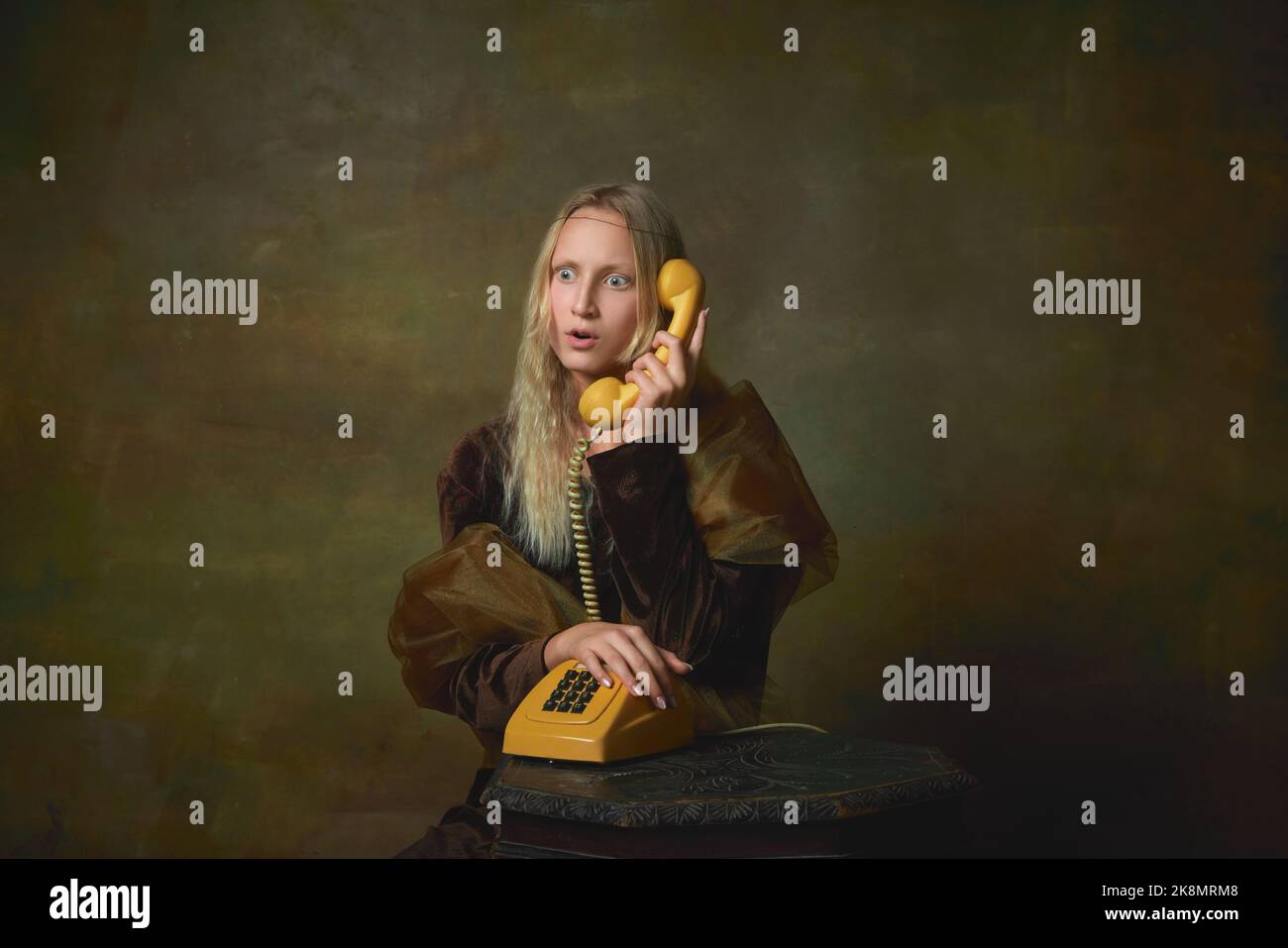 Shocked young girl as Mona Lisa picture talking on retro phone over ...