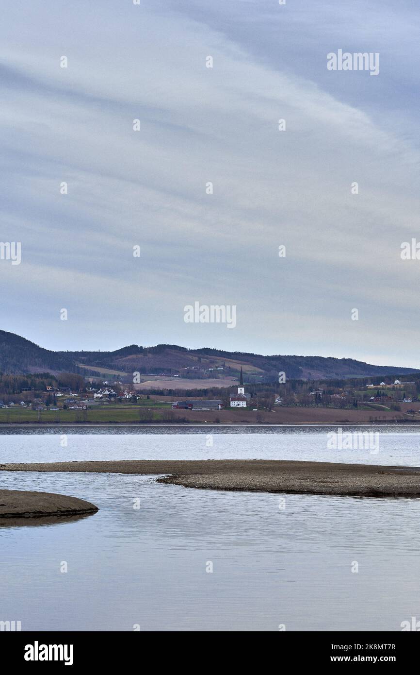 A vertical of the lake Mjosa in Norway with the background of its shore ...