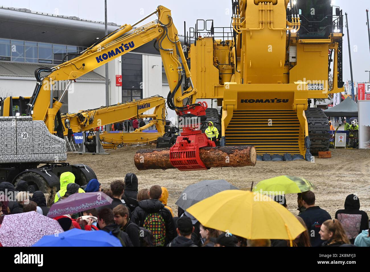 Large crowd, visitors on the open-air site with construction machinery ...