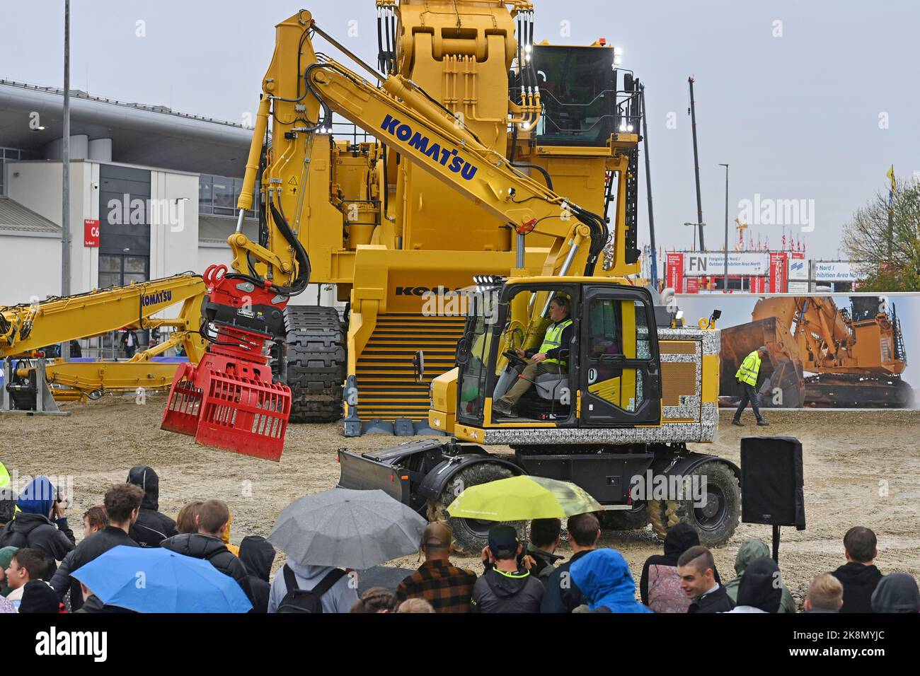 Large crowd, visitors on the open-air site with construction machinery ...