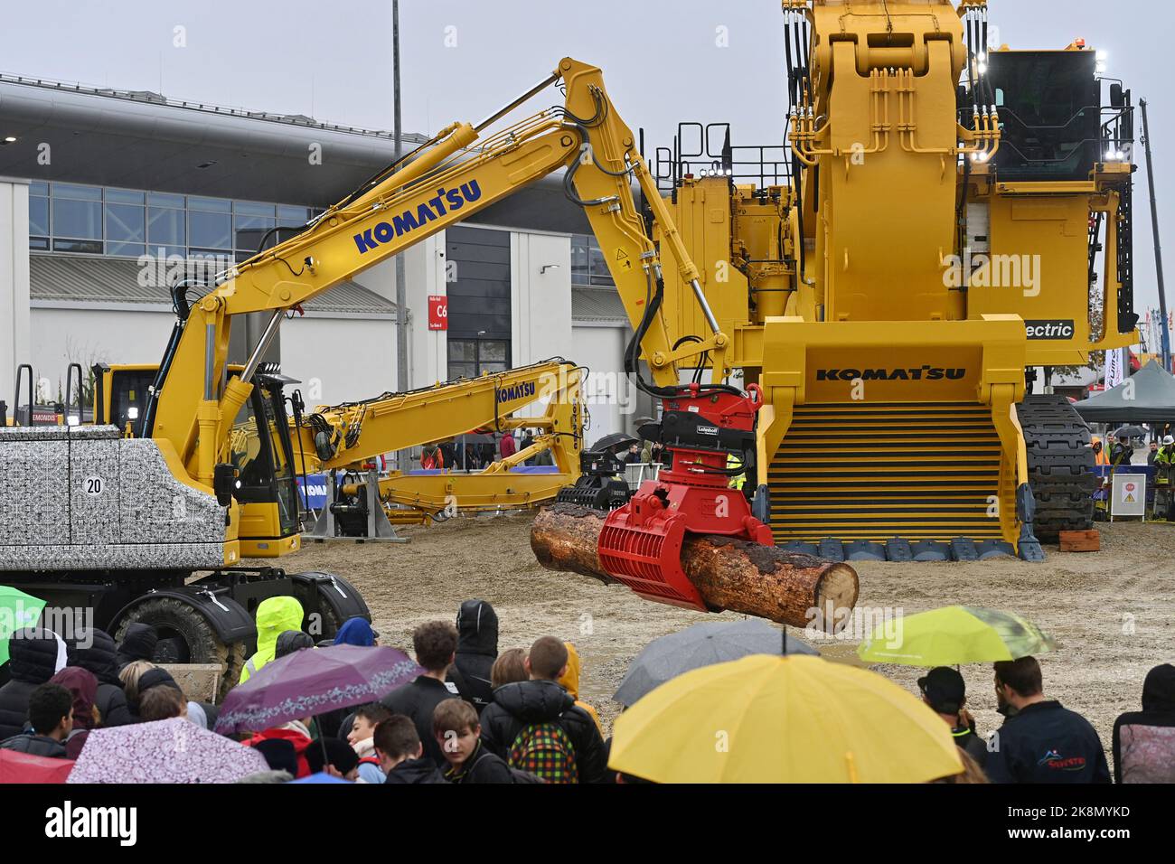 Large crowd, visitors on the open-air site with construction machinery ...