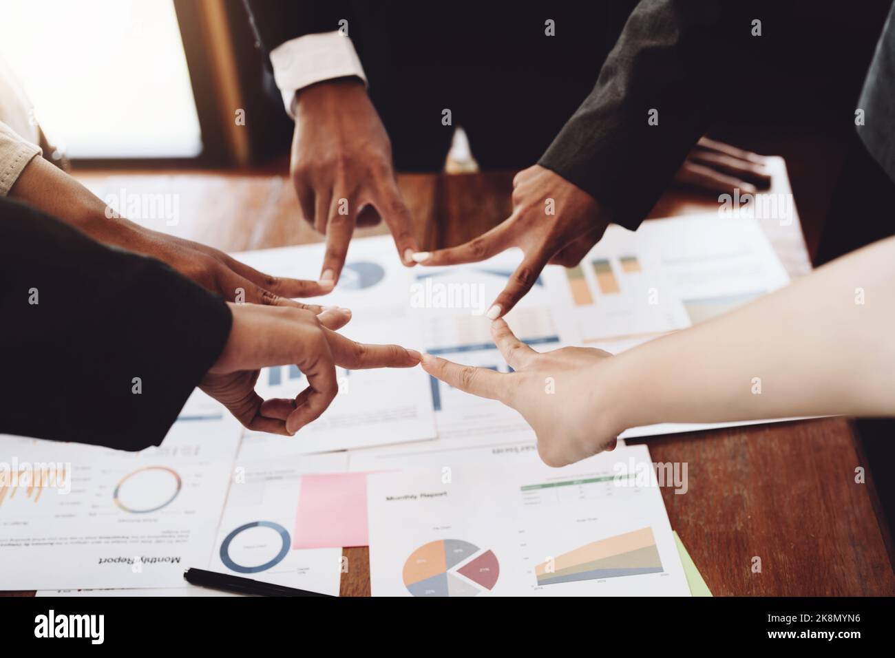 Group of business people showing merger symbol, together concept Stock ...