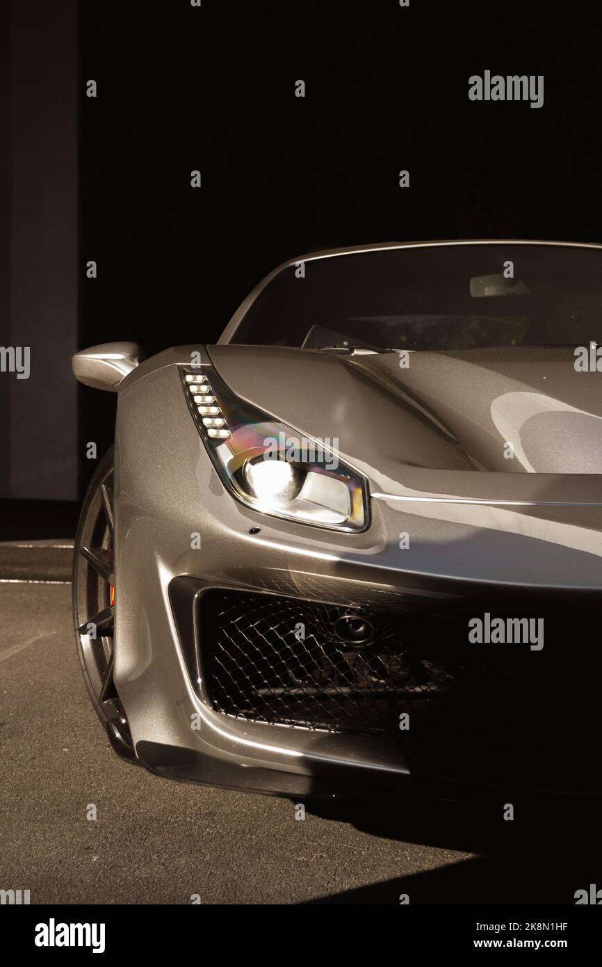 The vertical partial view of a gray Ferrari 488 Pista Tailor at night ...
