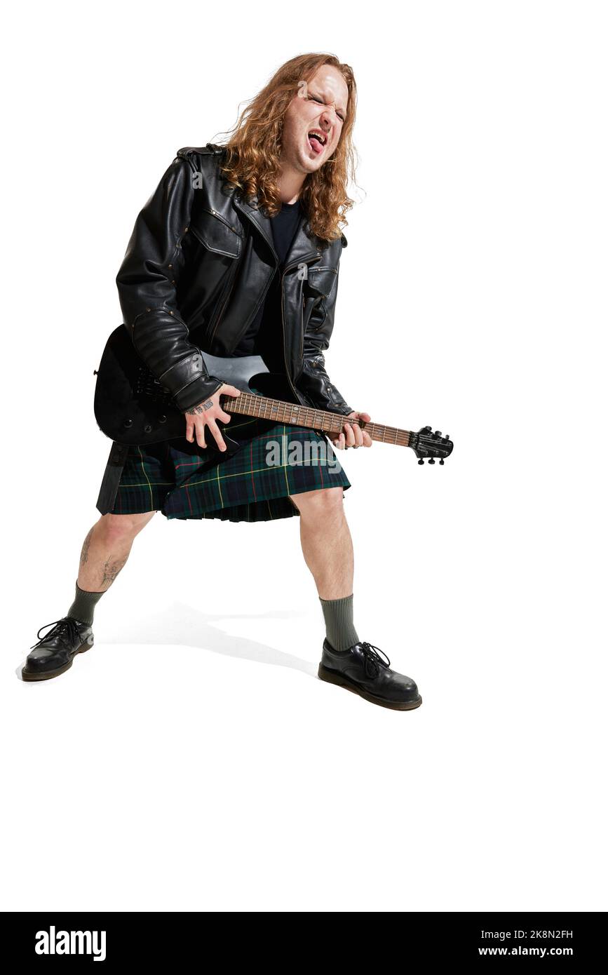 Portrait of expressive young man with long hair, rock musician playing ...