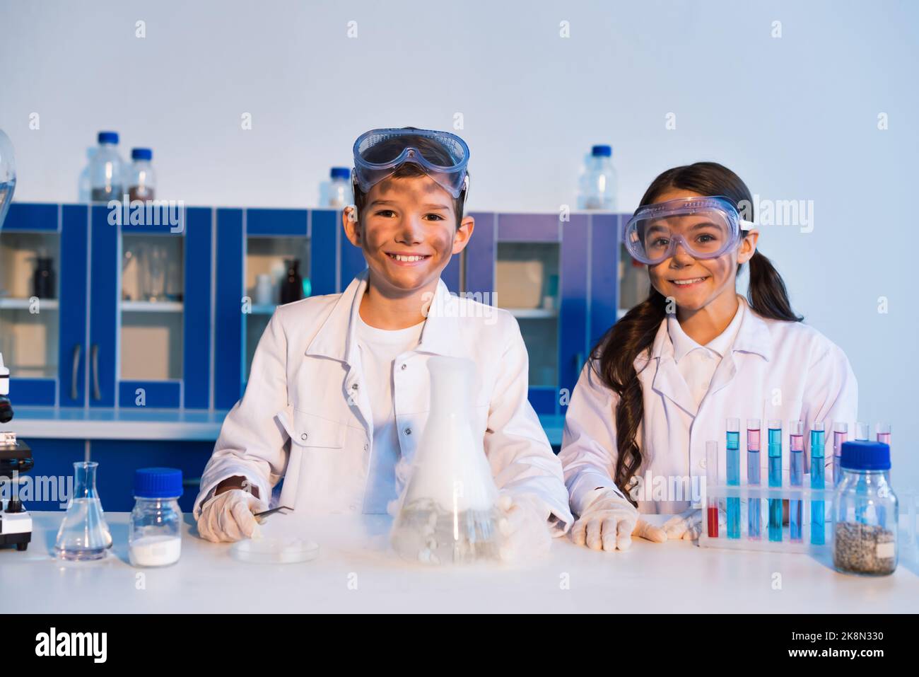 happy kids with dirty faces looking at camera during chemical ...