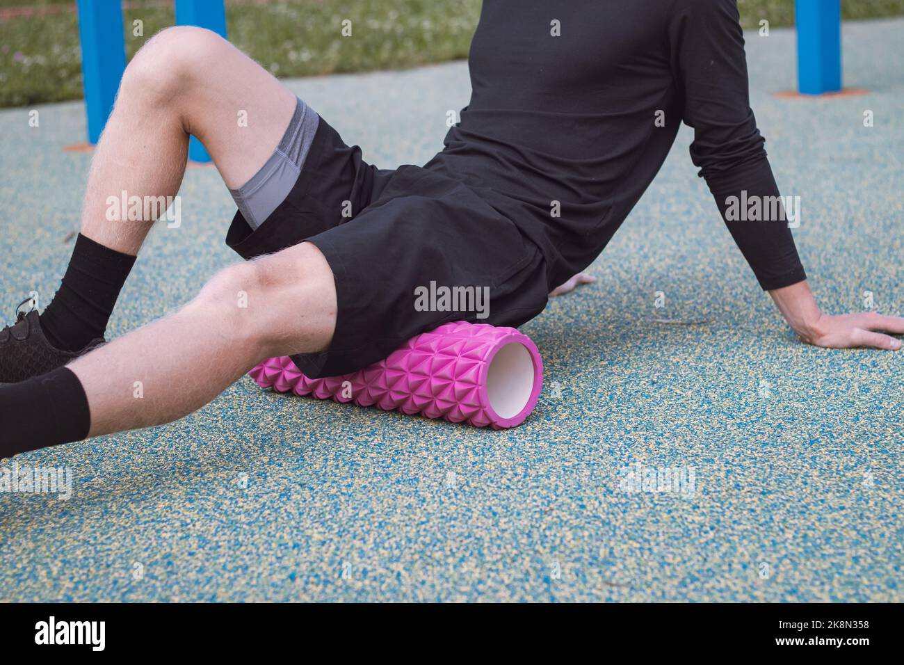 Fitness trainer exercises and warms up the lower part of the body with ...