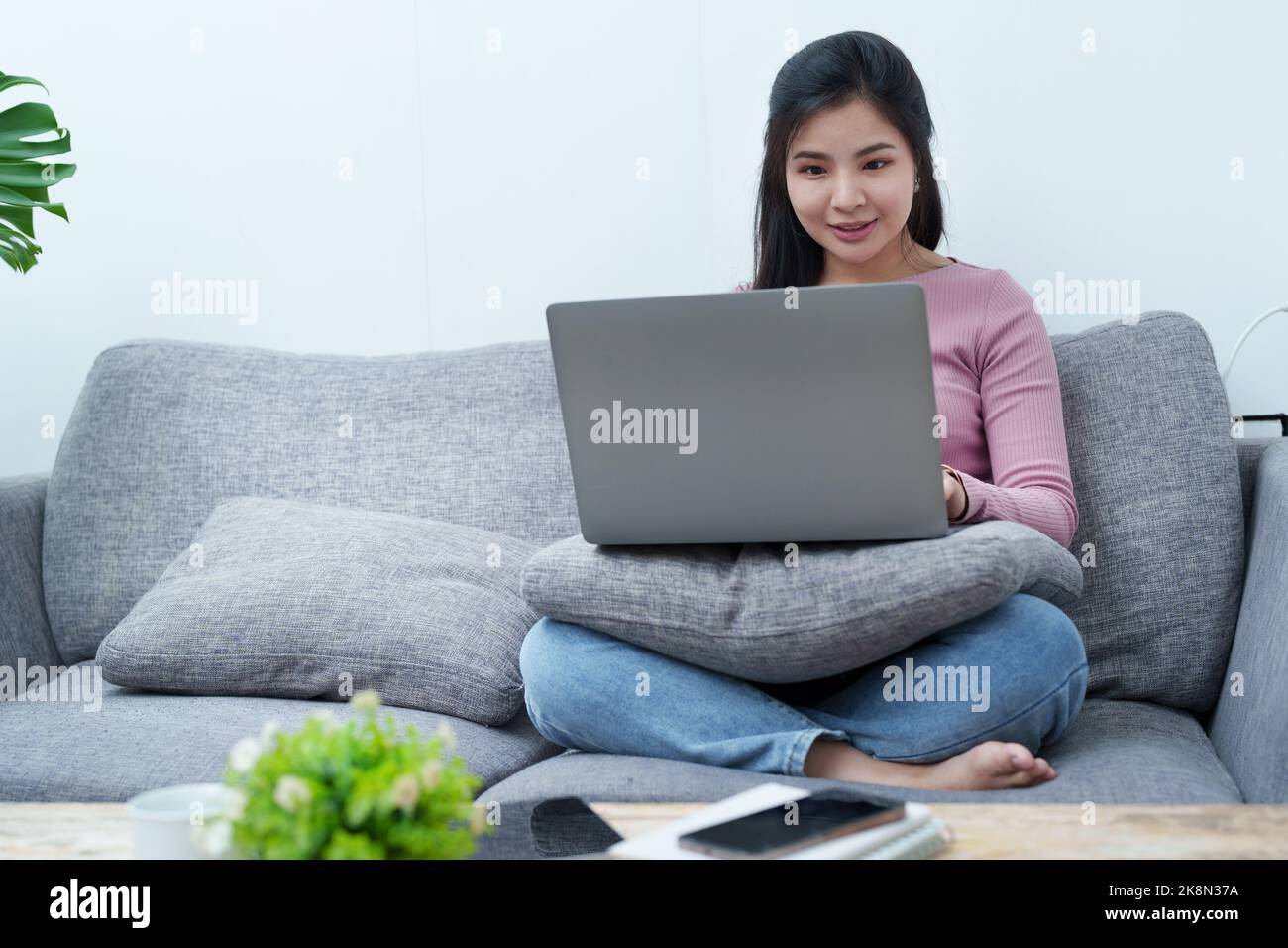 Portrait of a beautiful Asian teenage girl using a computer Stock Photo ...