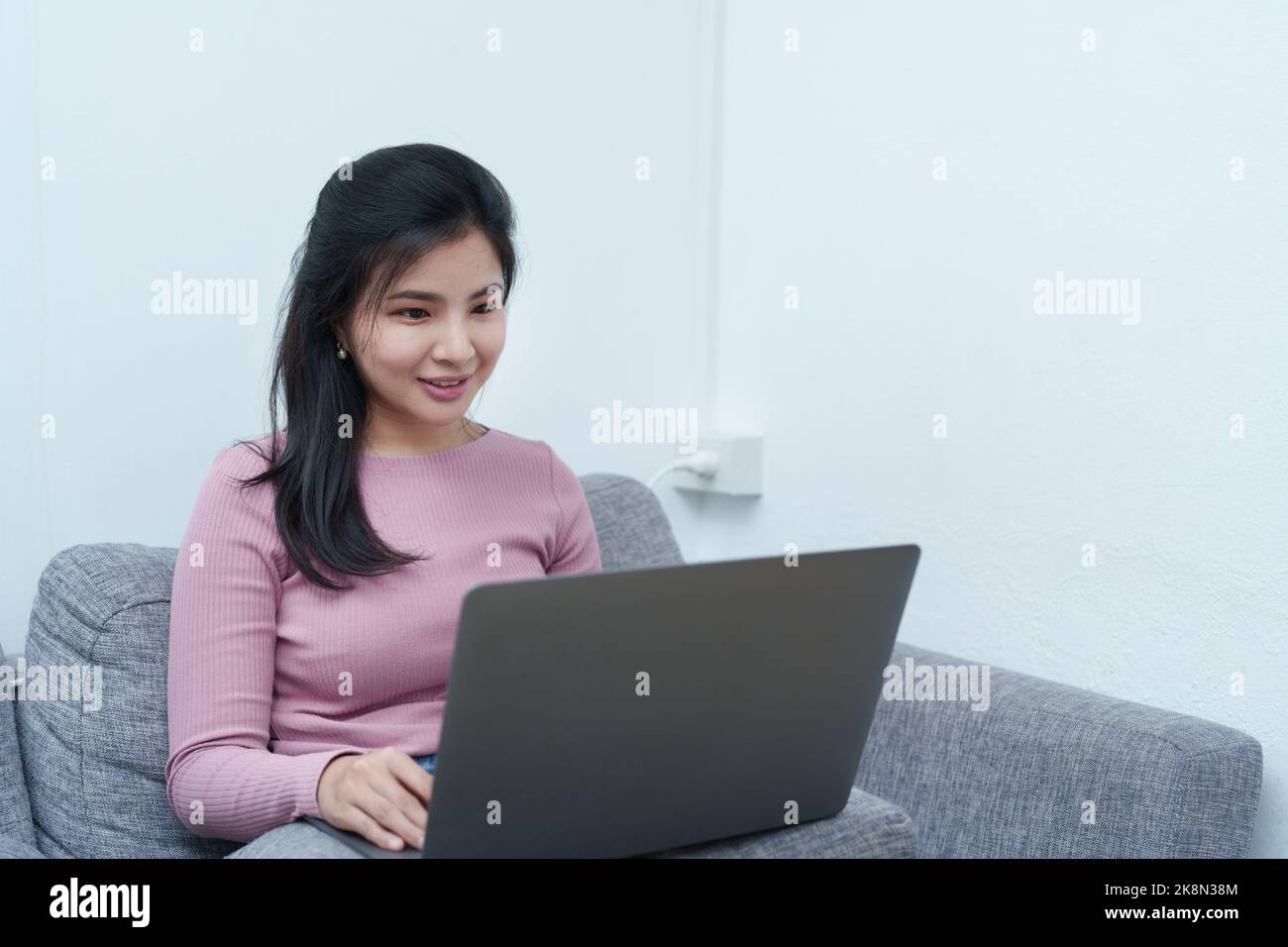 Portrait of a beautiful Asian teenage girl using a computer Stock Photo ...