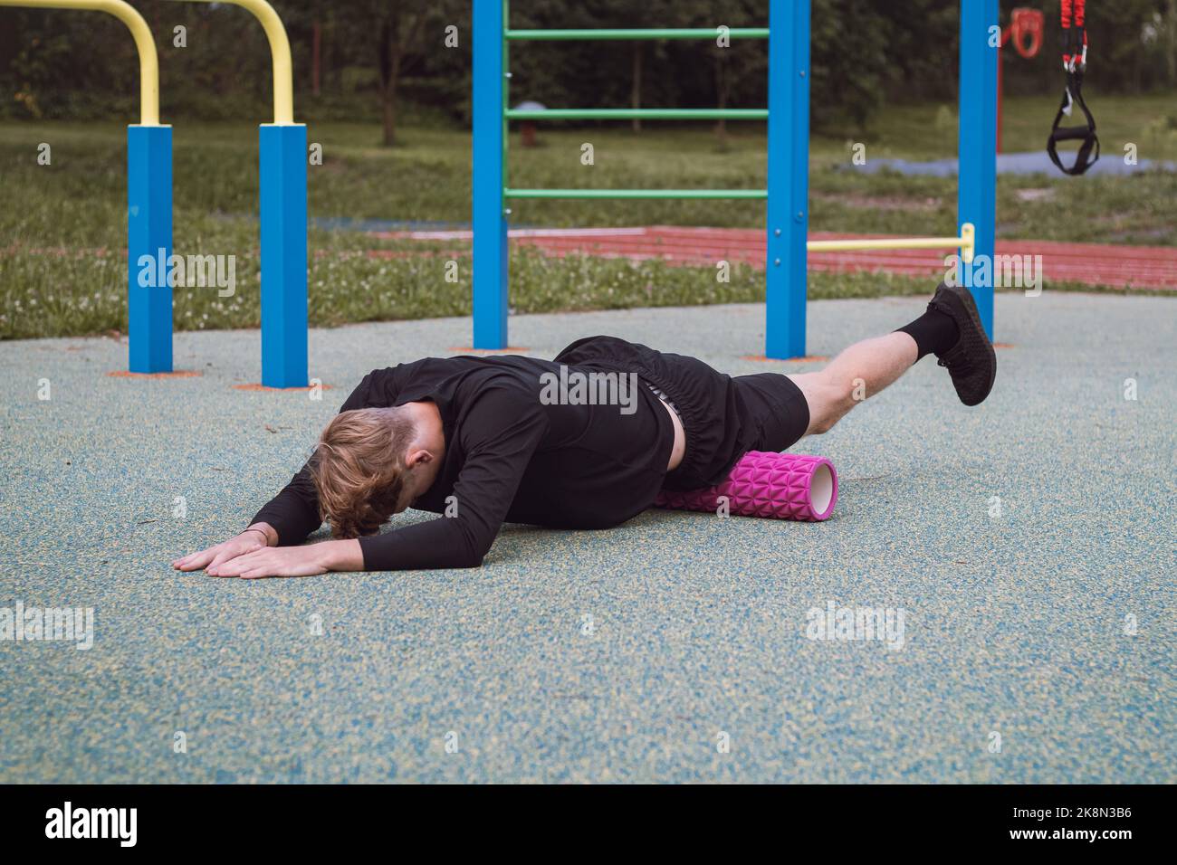 Fitness Trainer Exercises And Warms Up The Lower Part Of The Body With The Help Of A Massage