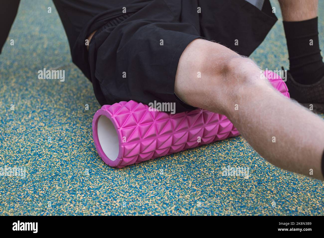 Fitness Trainer Exercises And Warms Up The Lower Part Of The Body With The Help Of A Massage