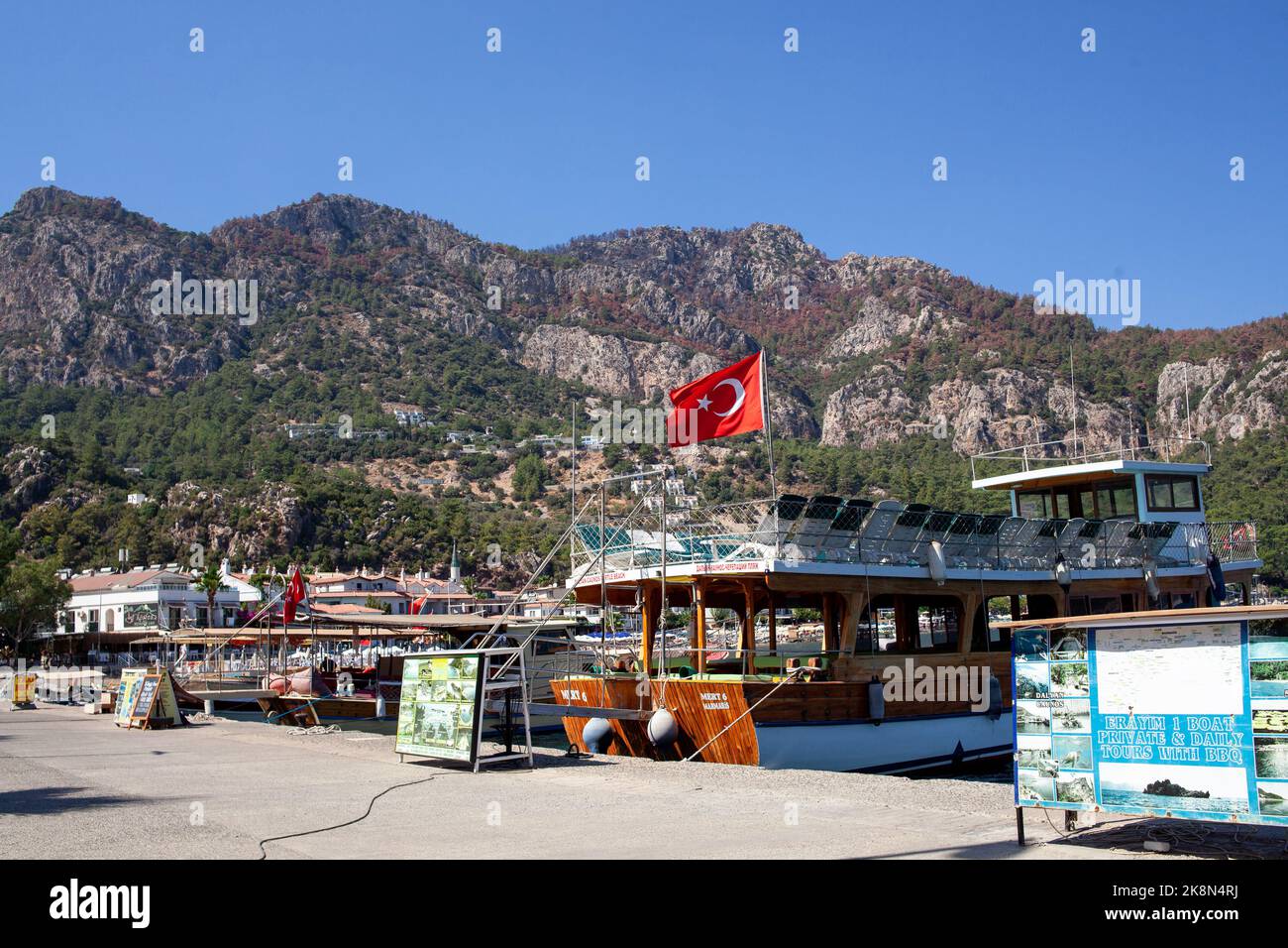 Promenade street in Turunc marine with tourist ships and excursion ...