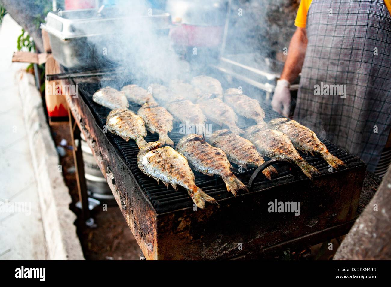 Grilled fish. Grilling dorada fish on grill. Frying fish on grill in ...