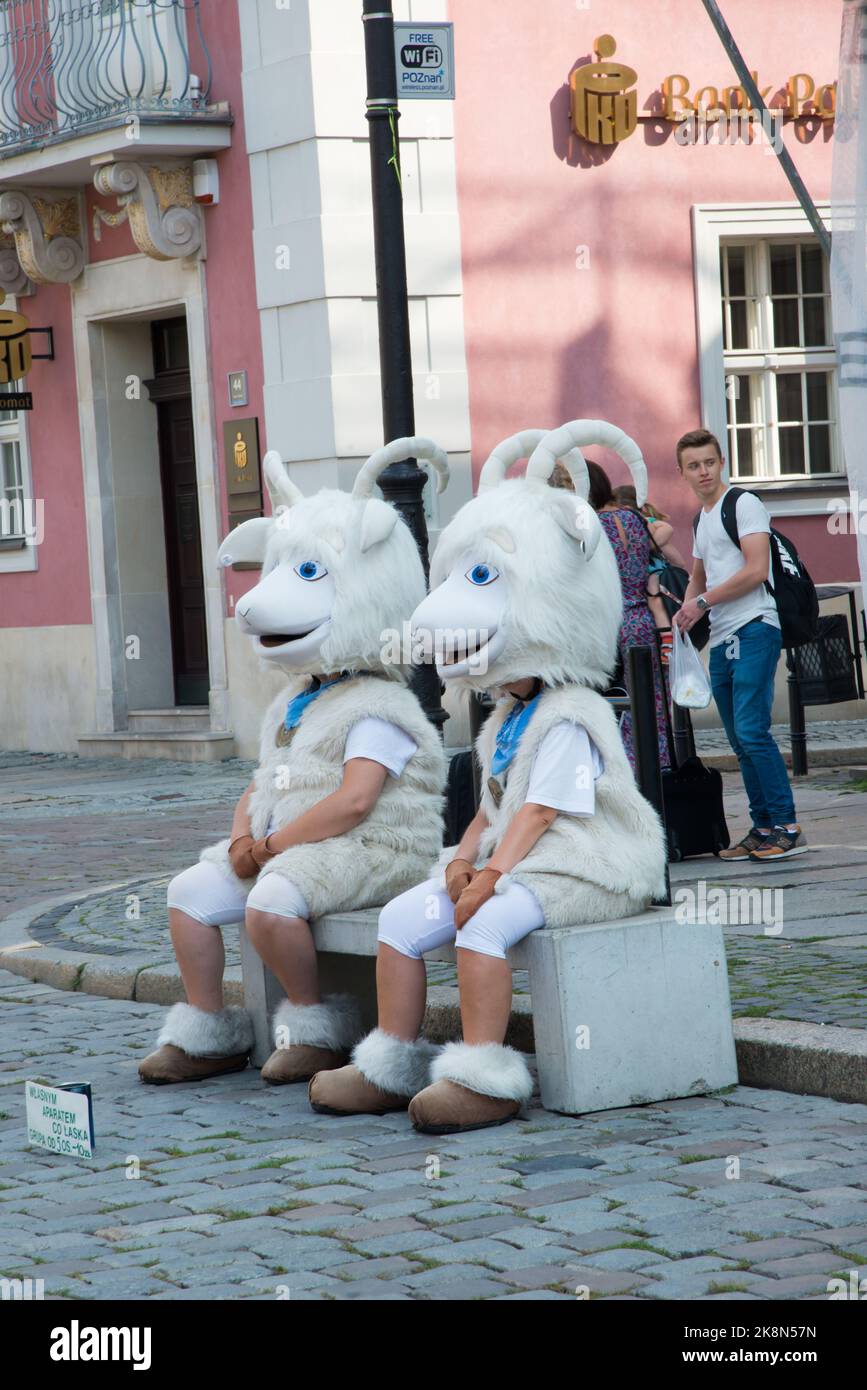 A vertical view of two people sitting on the bench while wearing ...