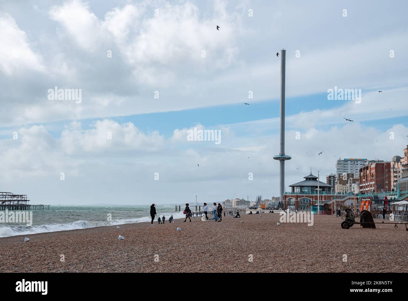 People walking down the promenade near the beach in Brighton Stock ...