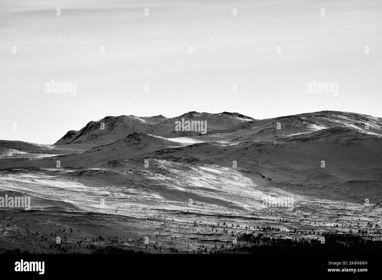 A grayscale of snowy mountains during the winter Stock Photo - Alamy