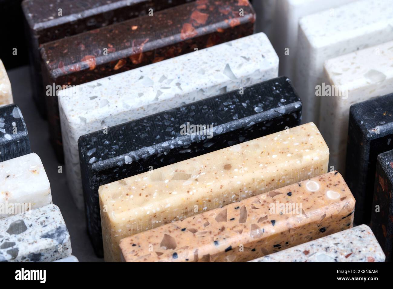Porcelain stoneware square samples laid on kitchen countertop as ...