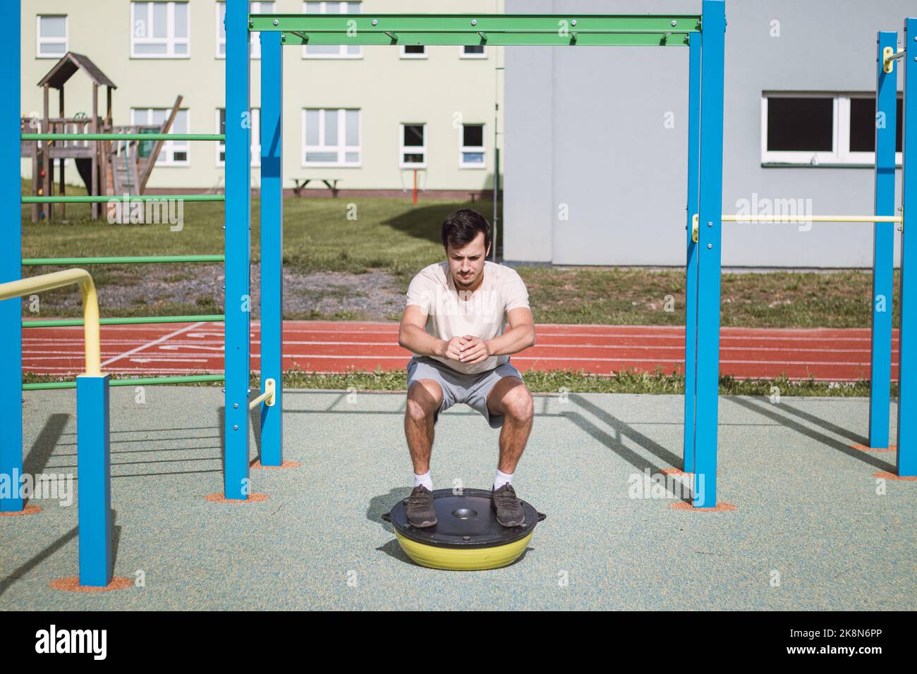 Professional athlete performs a squat with his own weight on a balance ...