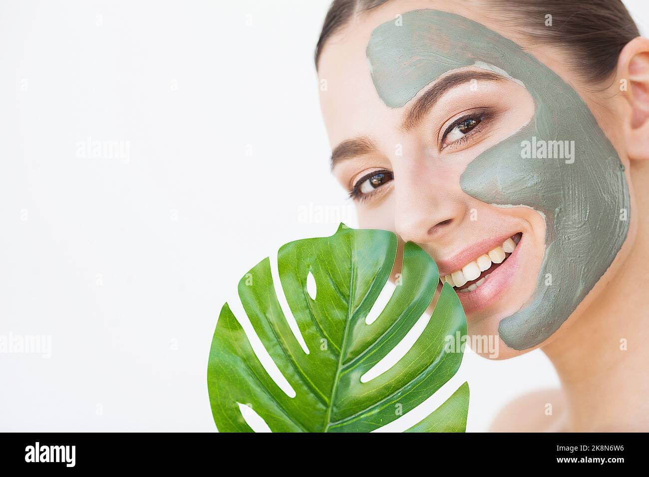 Skincare. Beautiful Woman With Perfect Skin Near Green Leaf Over White ...