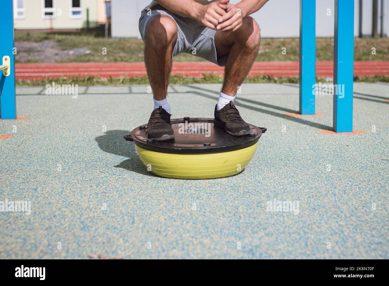 Professional athlete performs a squat with his own weight on a balance ...