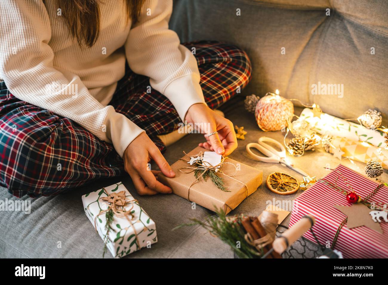 Woman s hands wrapping Christmas gift boxes, close up. Cropped female ...