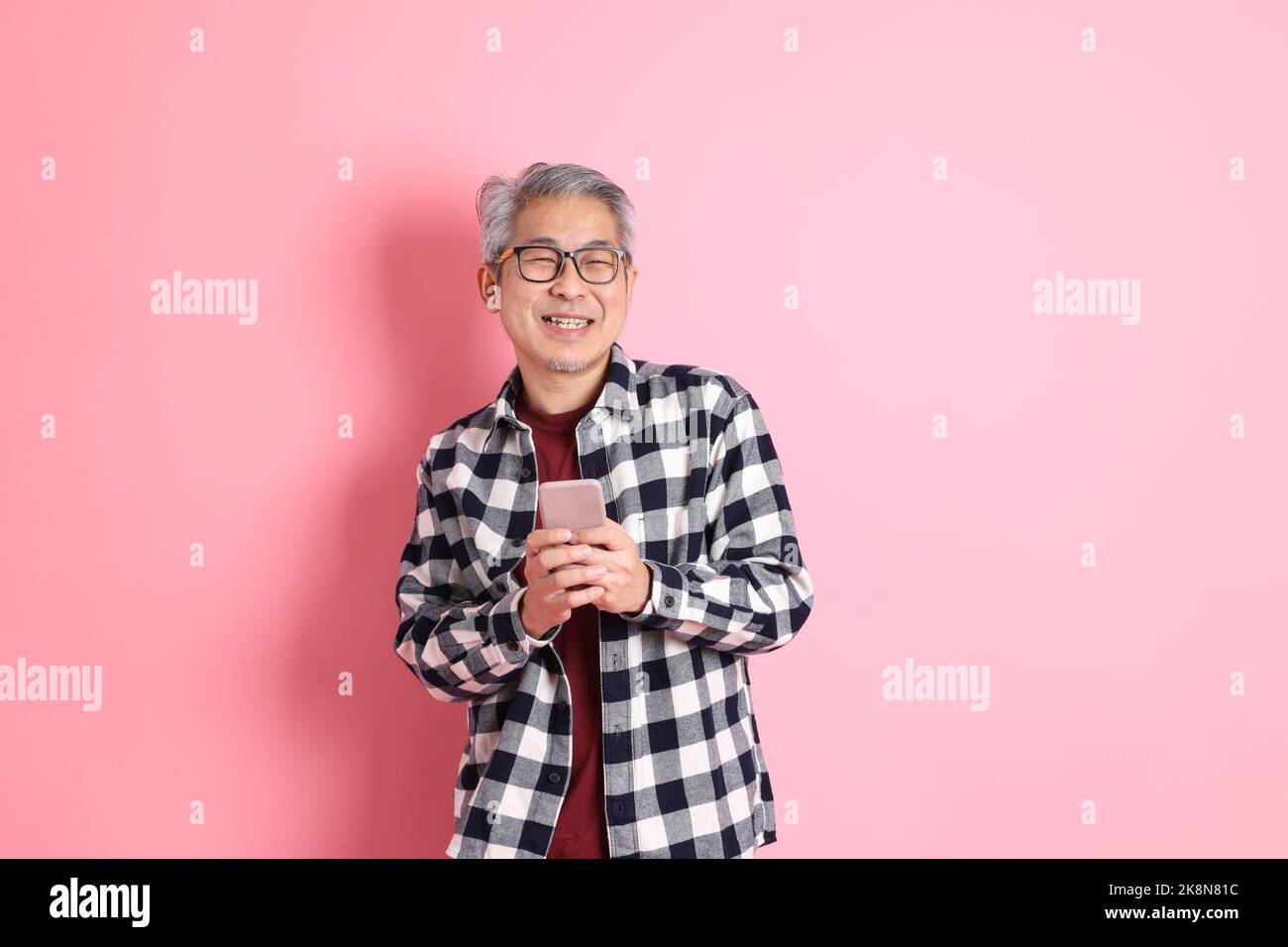 The 40s adult Asian man stnading on the pink background with casual ...