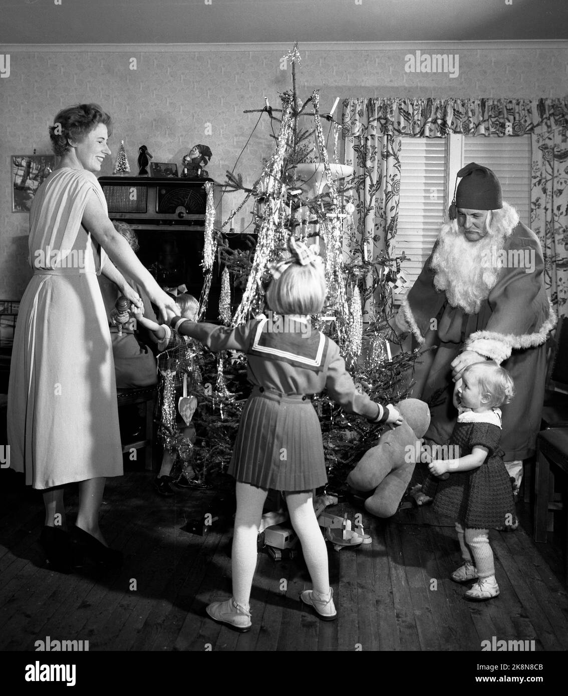 Oslo 195312. Finally, Christmas Eve has come. Adults and children walk ...