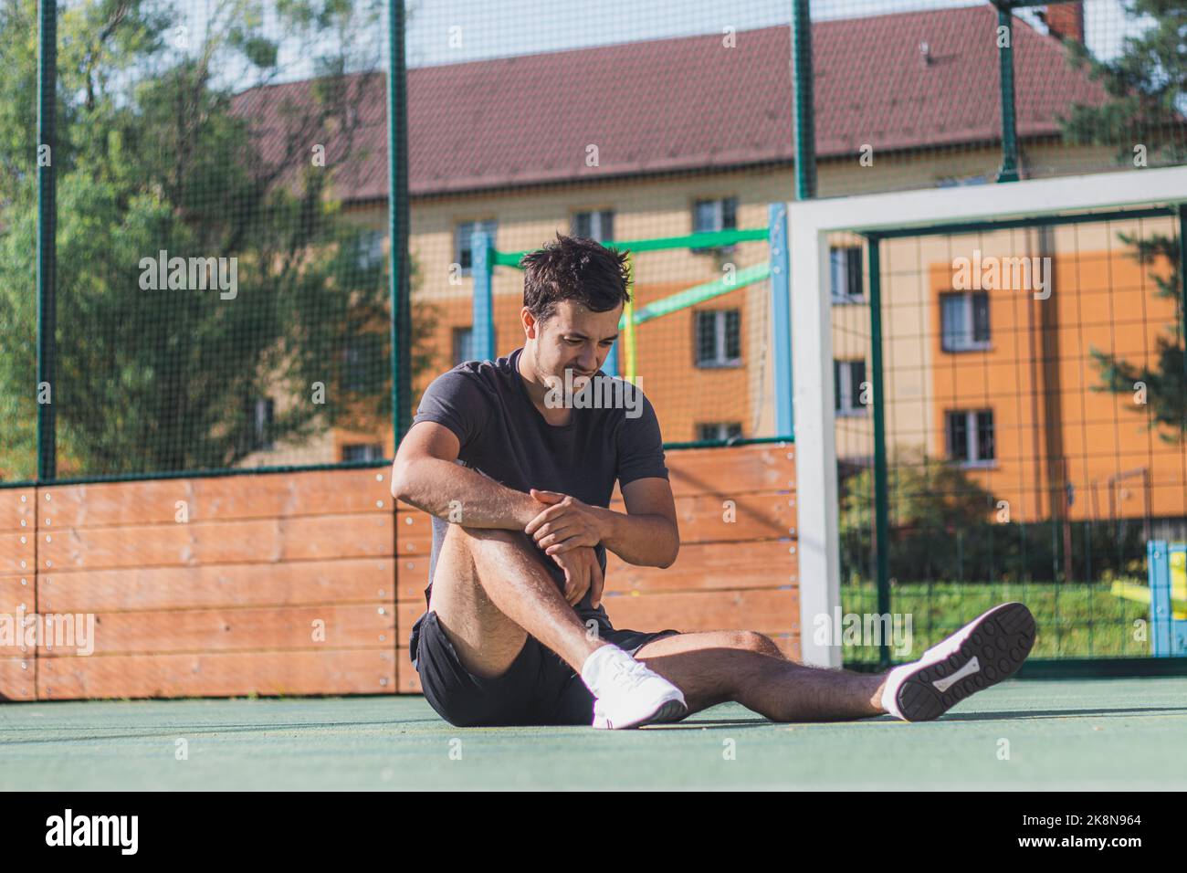 Black-haired athlete is resting heavily after a hard workout in the ...