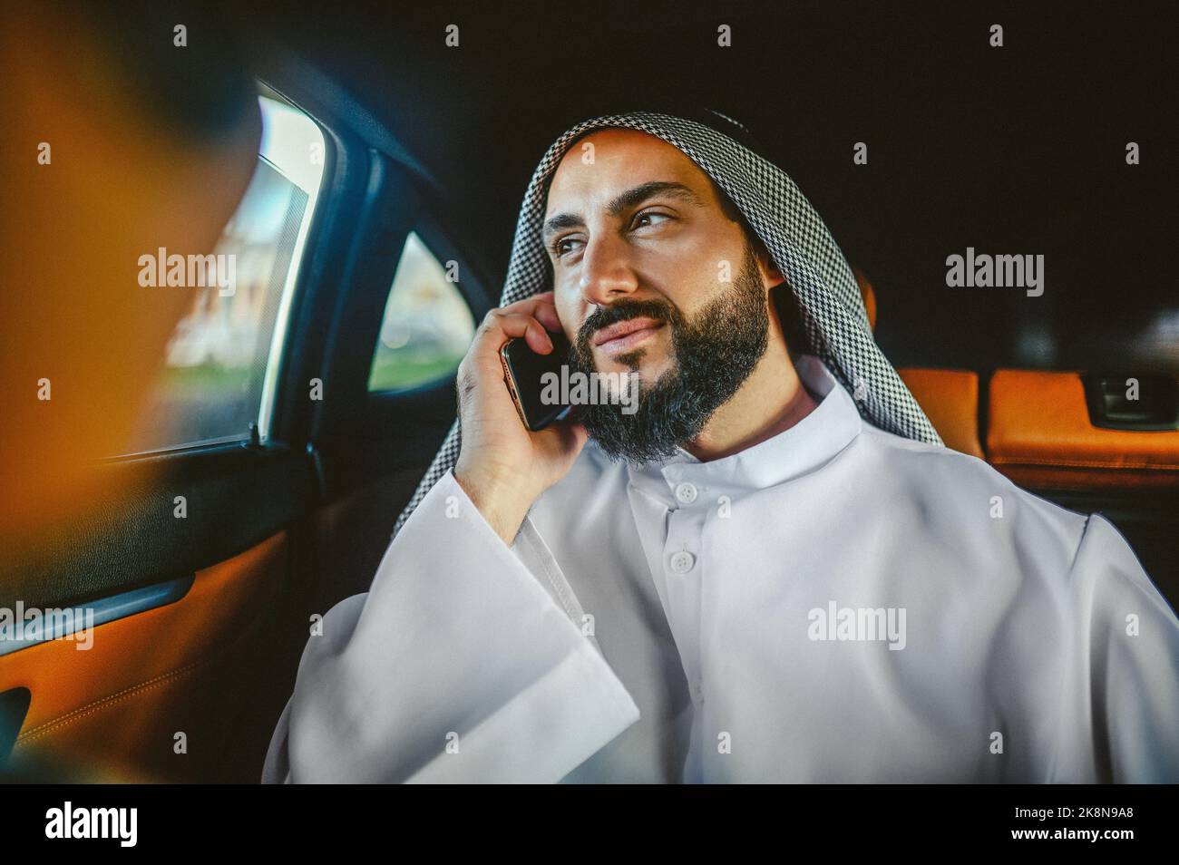 A saudi businessman in traditional clothing in a car Stock Photo - Alamy