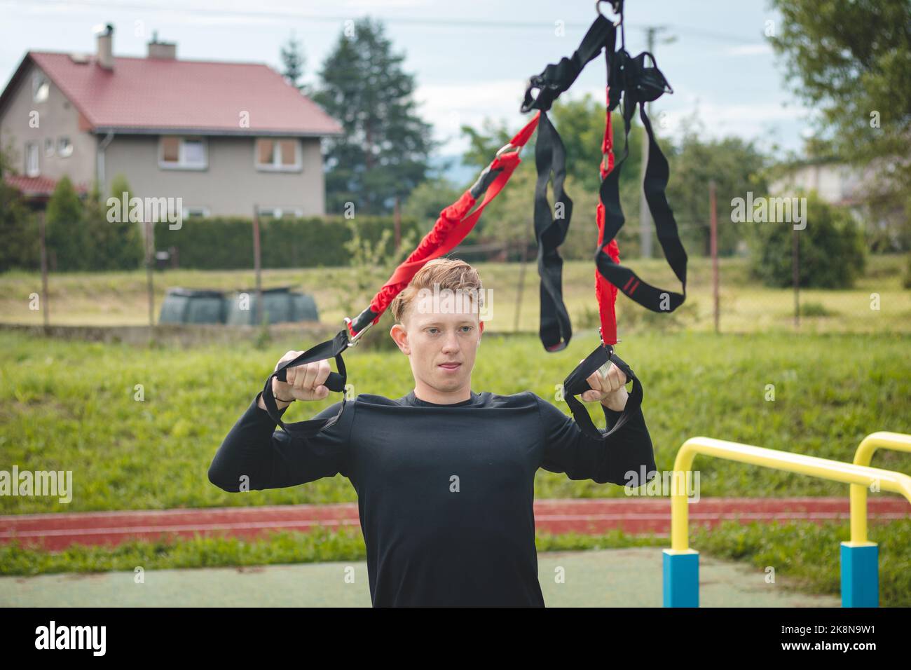 Professional athlete stretches and strengthens his arms, shoulders and ...