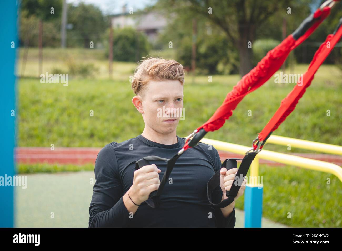 Professional athlete stretches and strengthens his arms, shoulders and ...