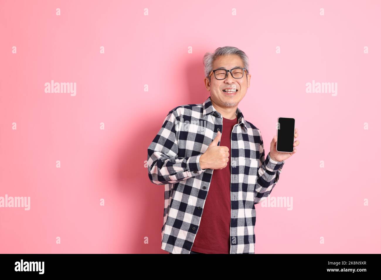 The 40s adult Asian man stnading on the pink background with casual ...