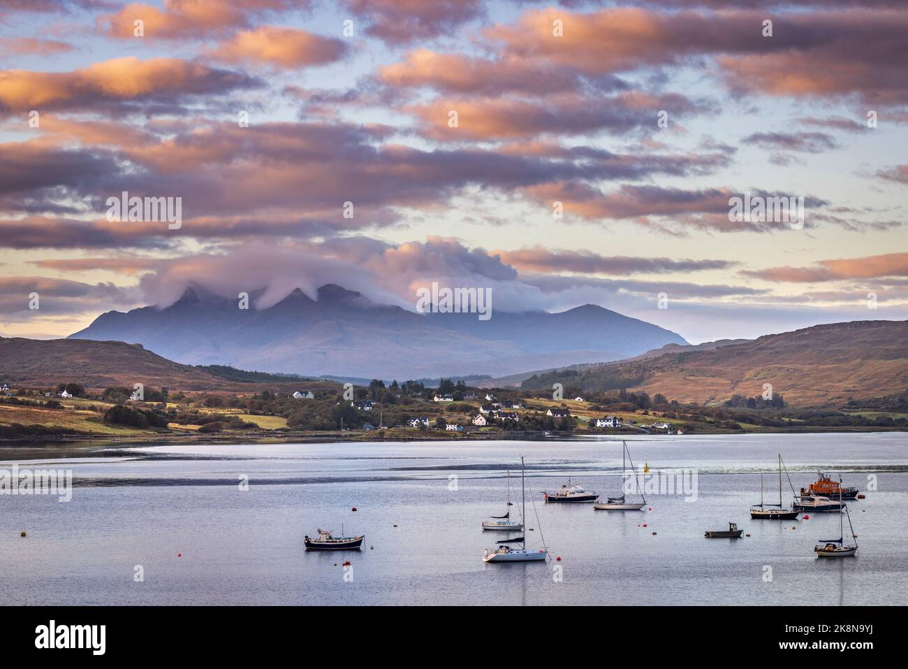 The cloud topped Cullin Hills across Portree Bay at dawn, Isle of Skye ...