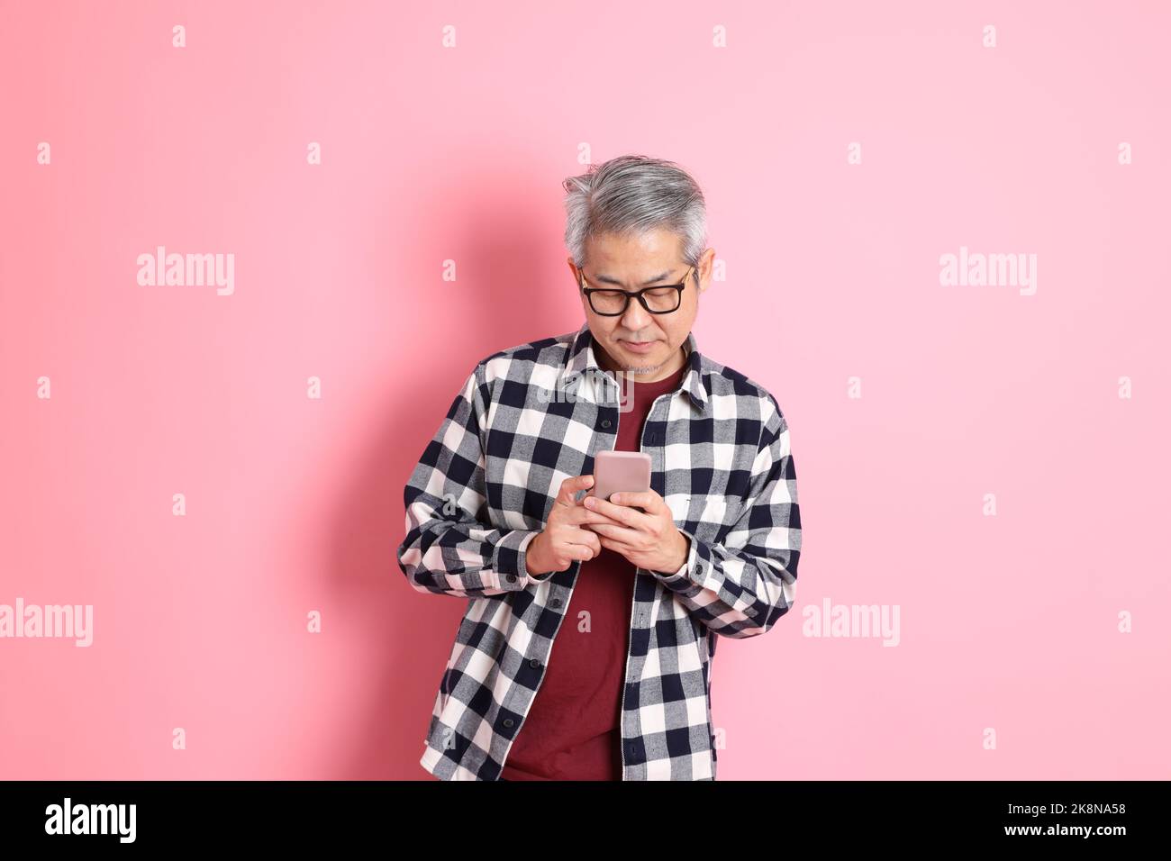 The 40s adult Asian man stnading on the pink background with casual ...
