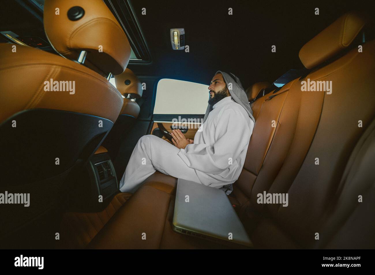 A young rich saudi in a leather car interior Stock Photo - Alamy