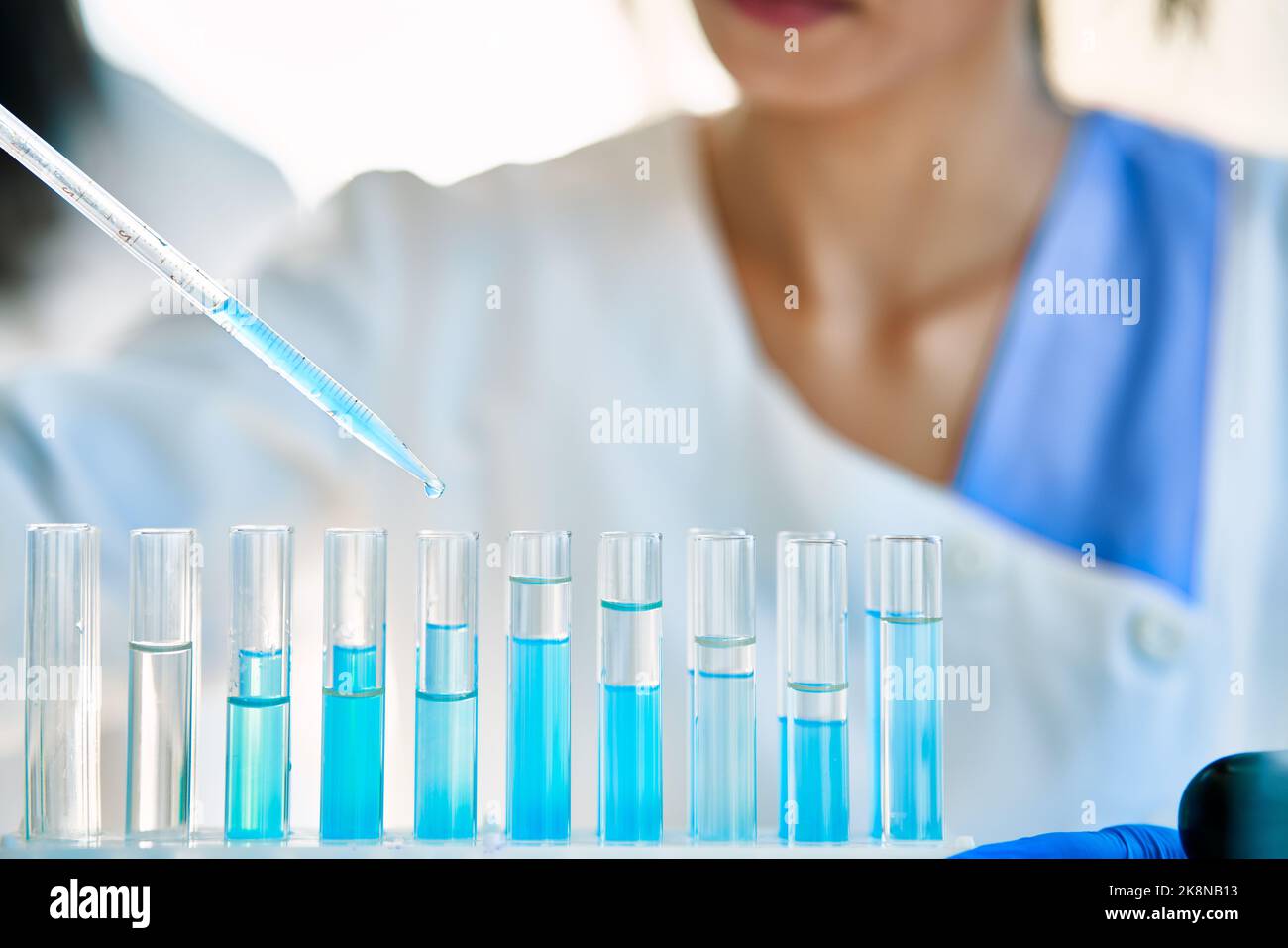 Test tubes with liquid in modern laboratory. Research scientist using ...