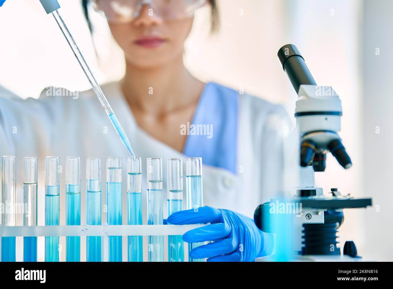 Test tubes with liquid in modern laboratory. Research scientist using ...