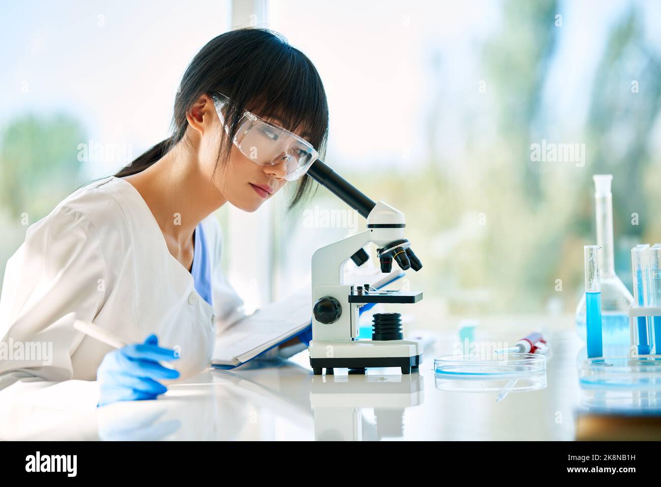 Scientist researcher working writing down analysis information at ...