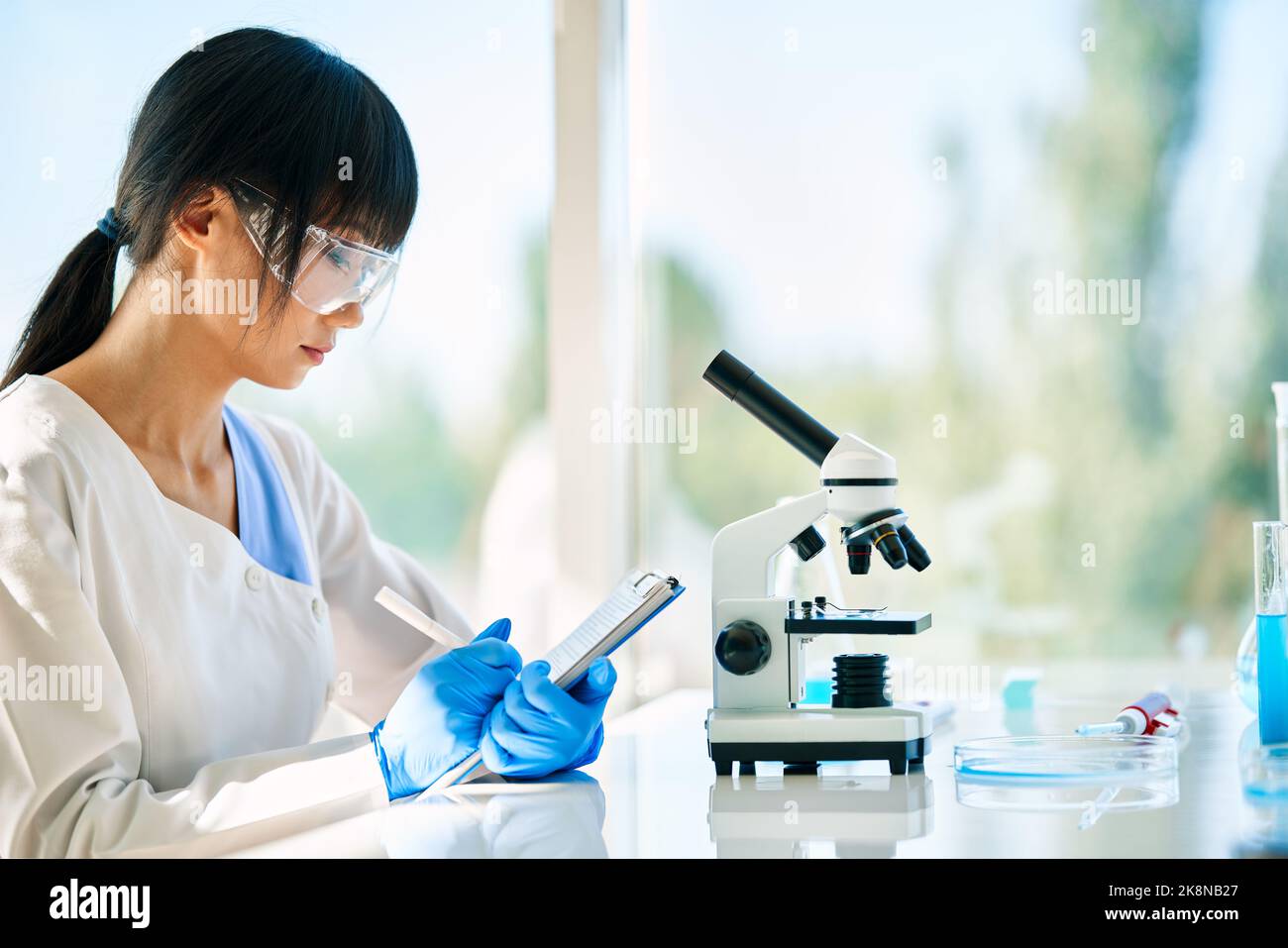 Scientist researcher working writing down analysis information at ...