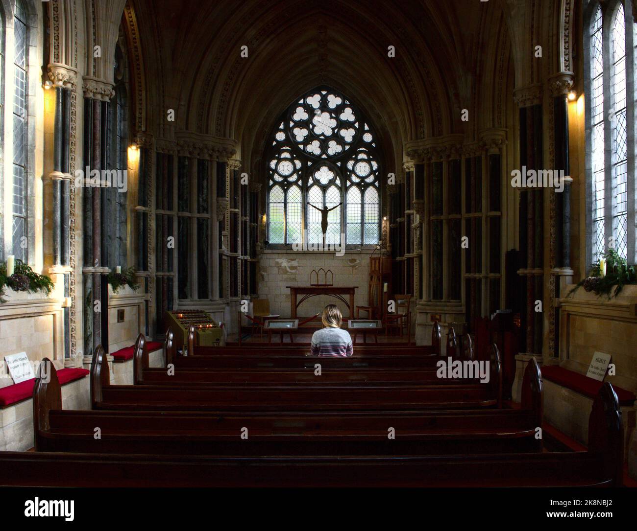 An interior view of Kylemore Abbey with a woman praying in Connemara ...