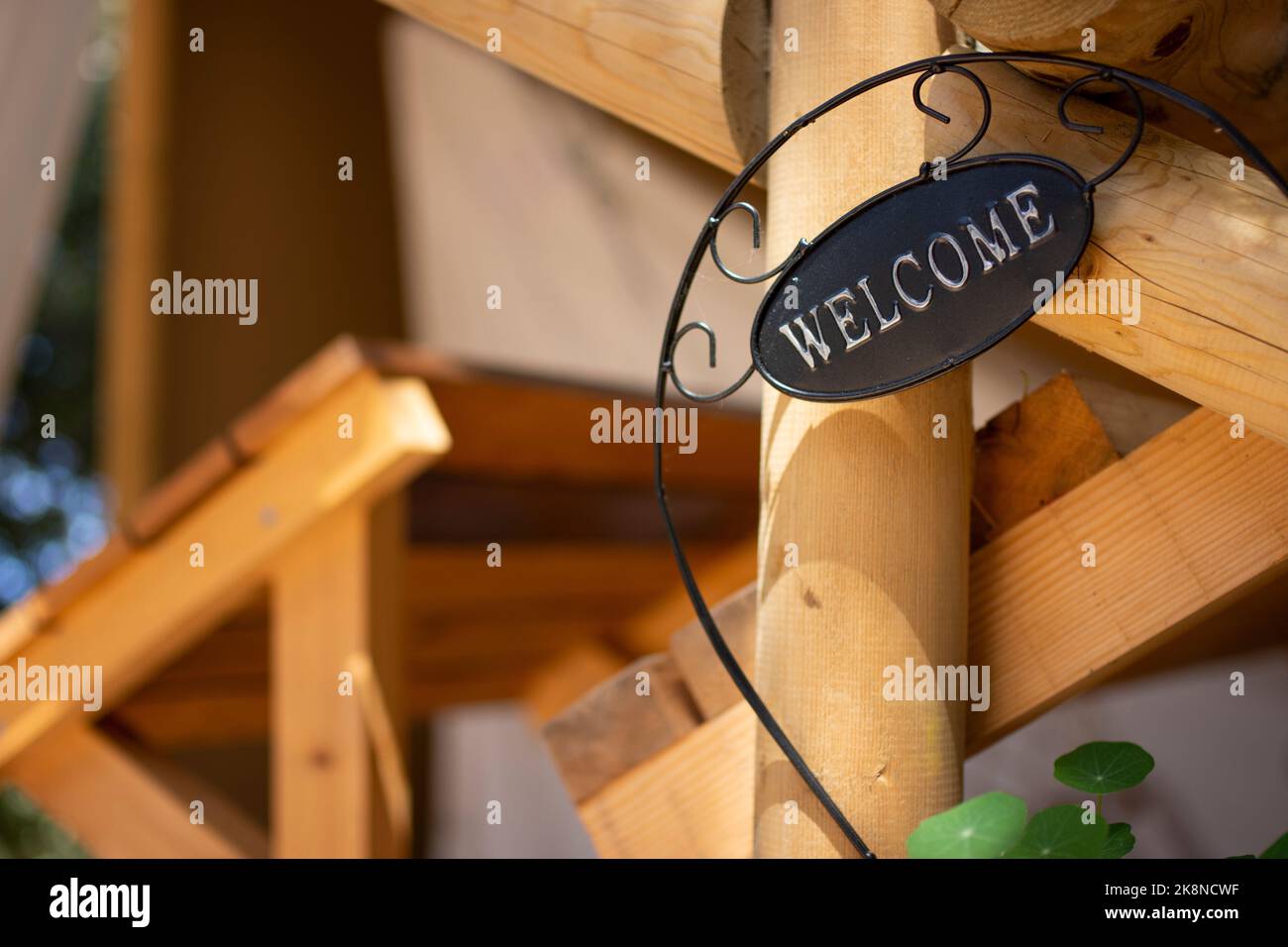 A small welcome sign on the wooden construction Stock Photo - Alamy