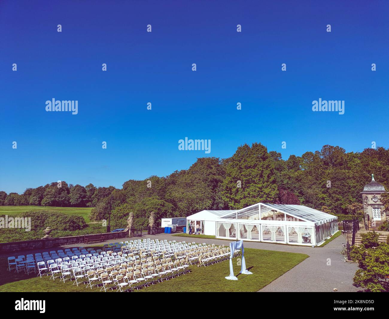 The aerial view of an empty outdoor wedding venue under the blue sky ...