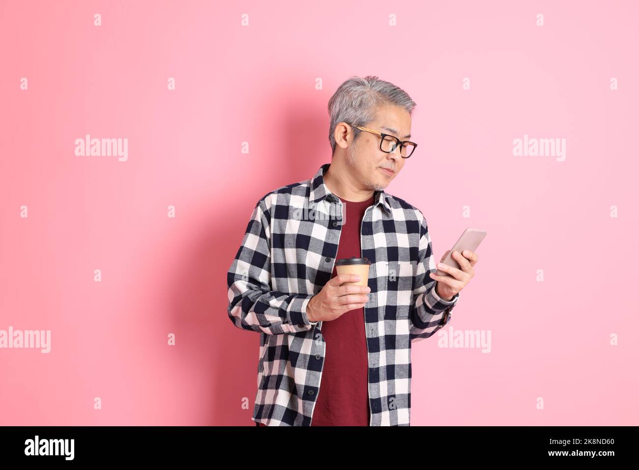 The 40s adult Asian man stnading on the pink background with casual ...