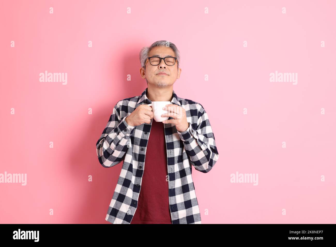 The 40s adult Asian man stnading on the pink background with casual ...