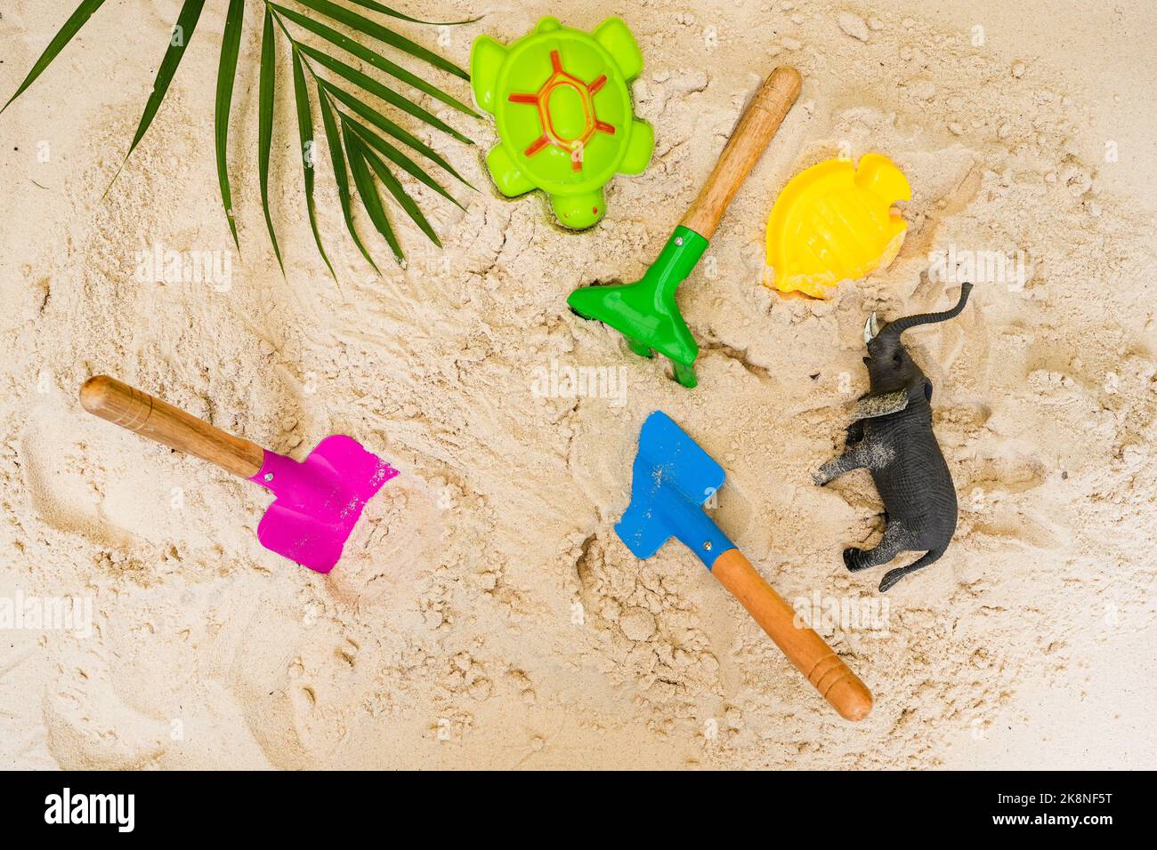 The top view of colorful toys on the sand including digging objects ...