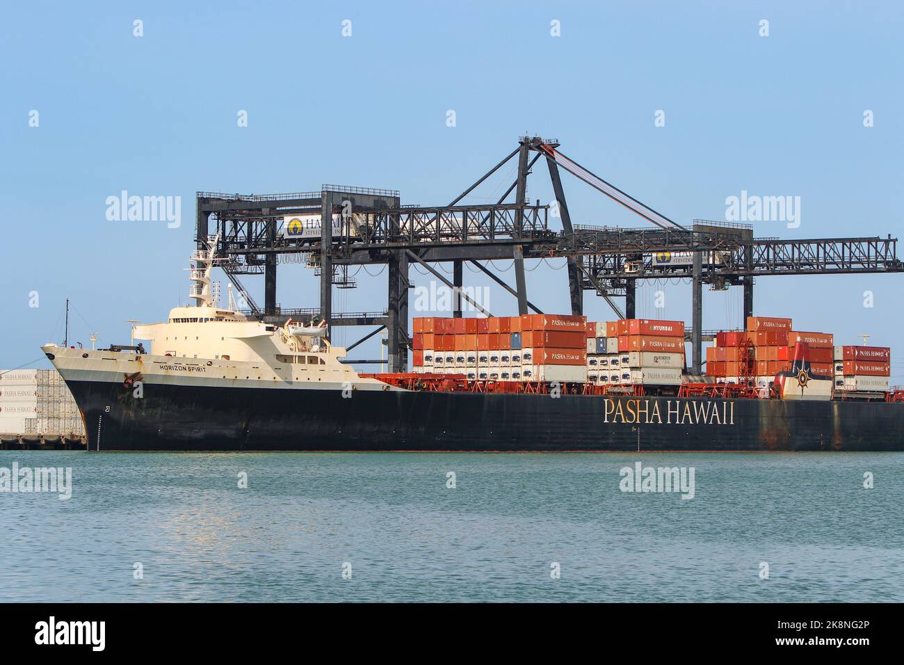 A Pasha offloading cargo docking station in Hawaii with ships, clear ...