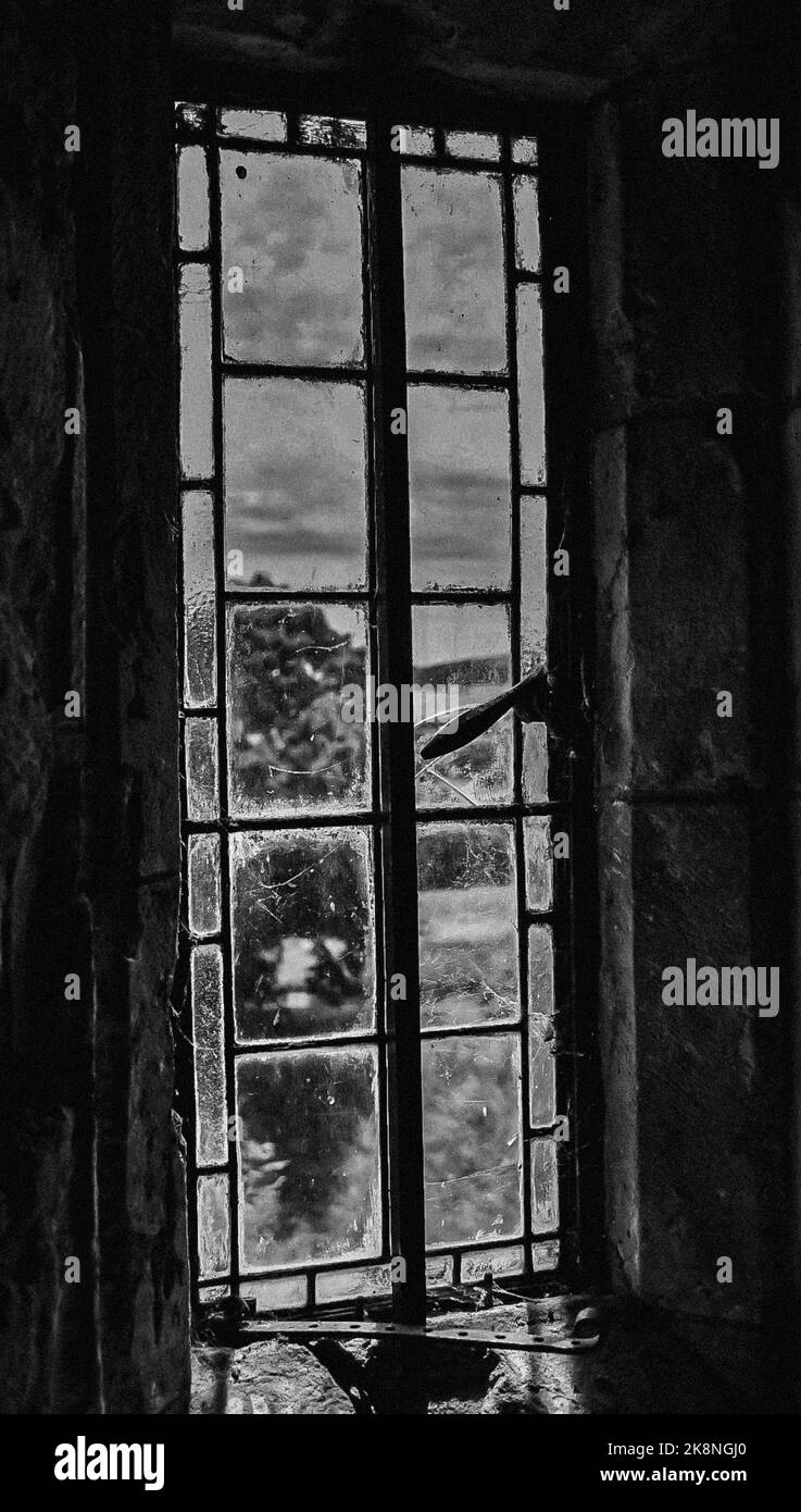 A vertical grayscale of a window looking at the Carisbrooke Castle Isle ...